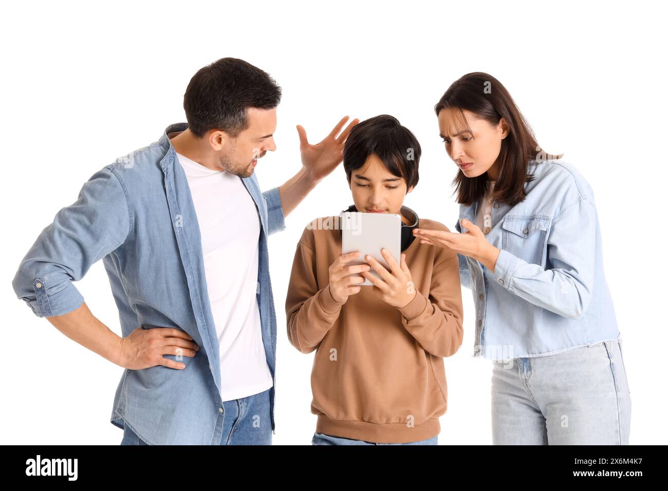 Teenage boy with tablet computer and his arguing parents on white ...