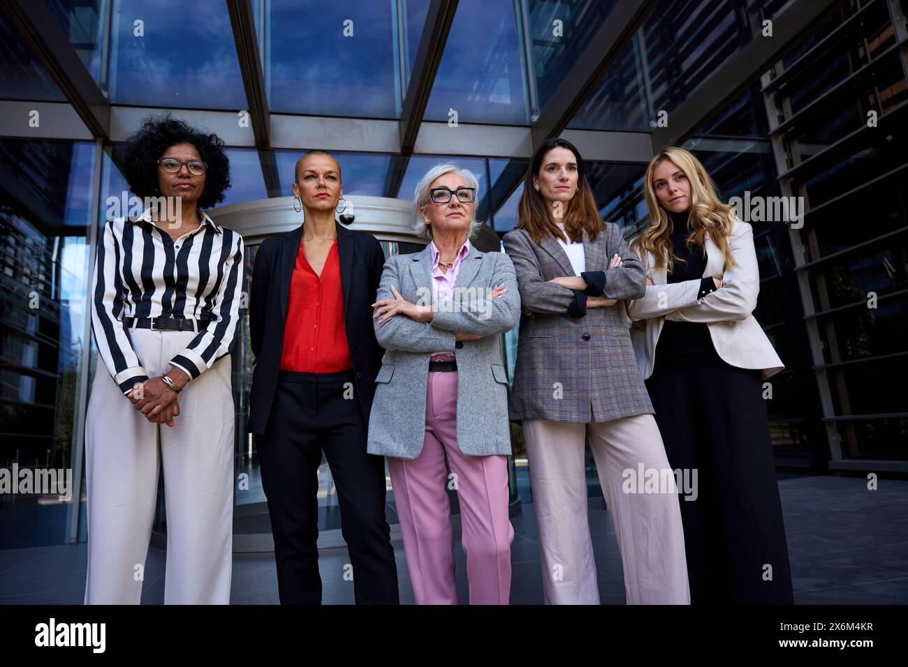 Team of cheerful business women of various ages and races happy outside ...