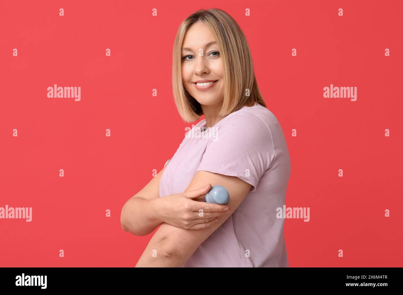 Woman with glucose sensor for measuring blood sugar level and ...