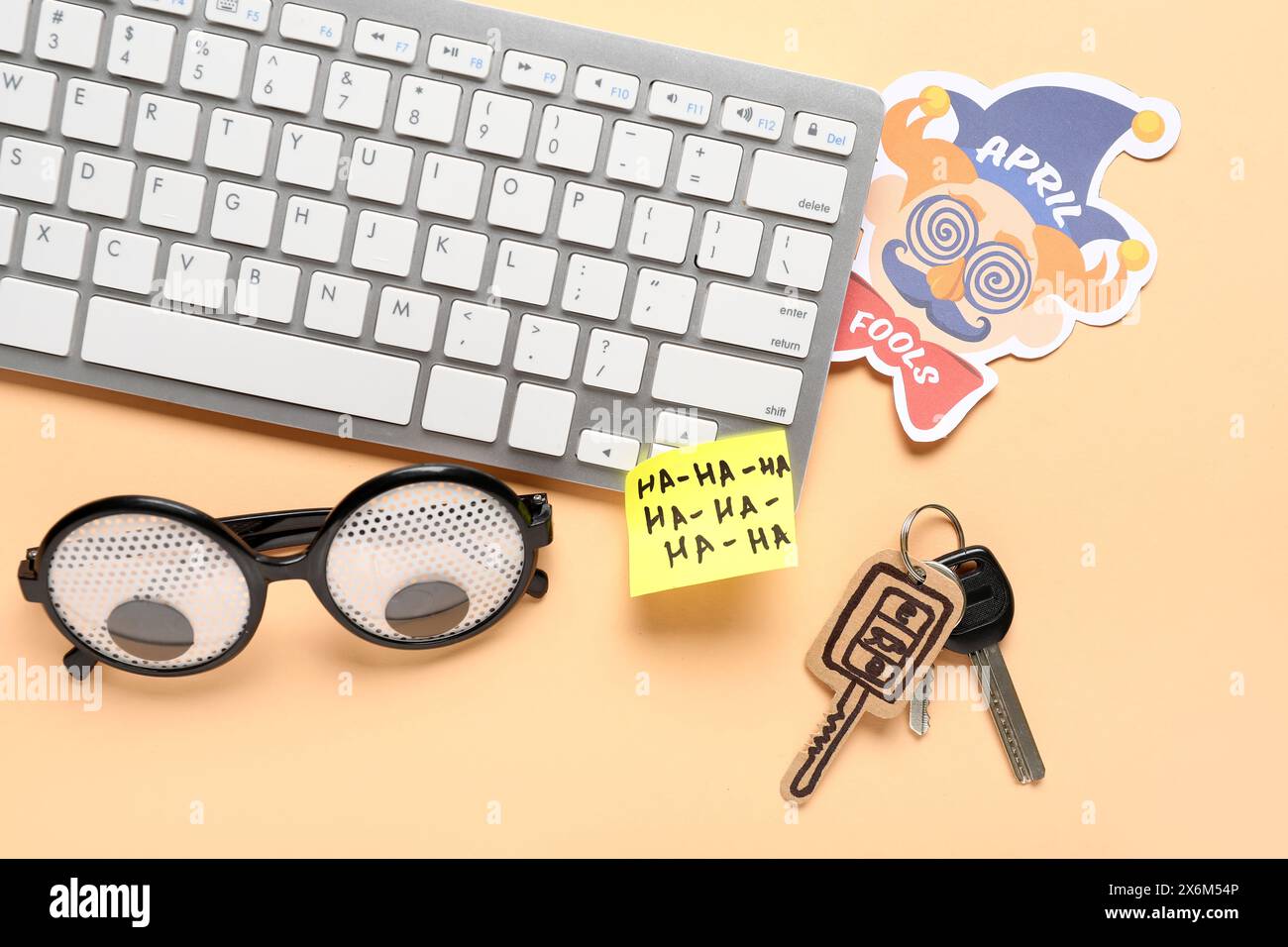 Carton key, sticky note, funny glasses and computer keyboard on beige ...