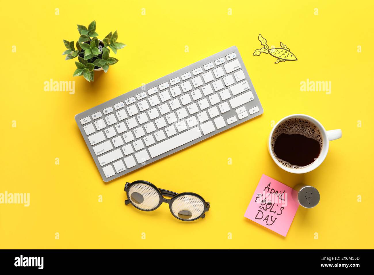 Computer keyboard, sticky note, salt and cup of coffee on yellow ...