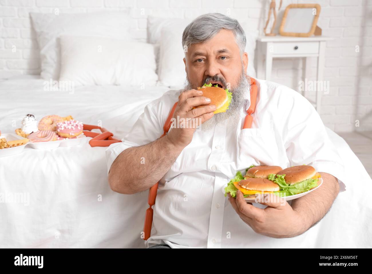 Overweight eating burgers hi-res stock photography and images - Alamy