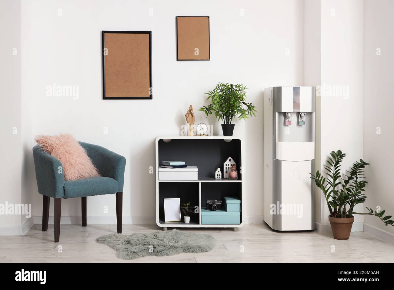 Interior of room with modern water cooler near white wall Stock Photo ...