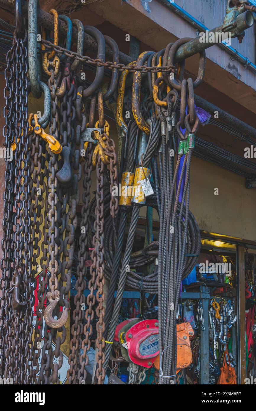 A selection of metal chains and hooks of various sizes hang from a ...
