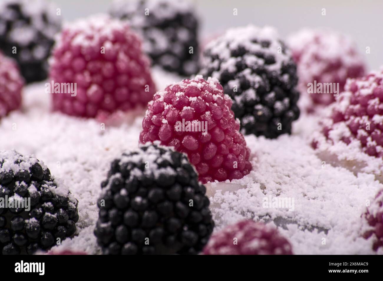 Blackberry and raspberry sweets dusted with icing sugar Stock Photo - Alamy