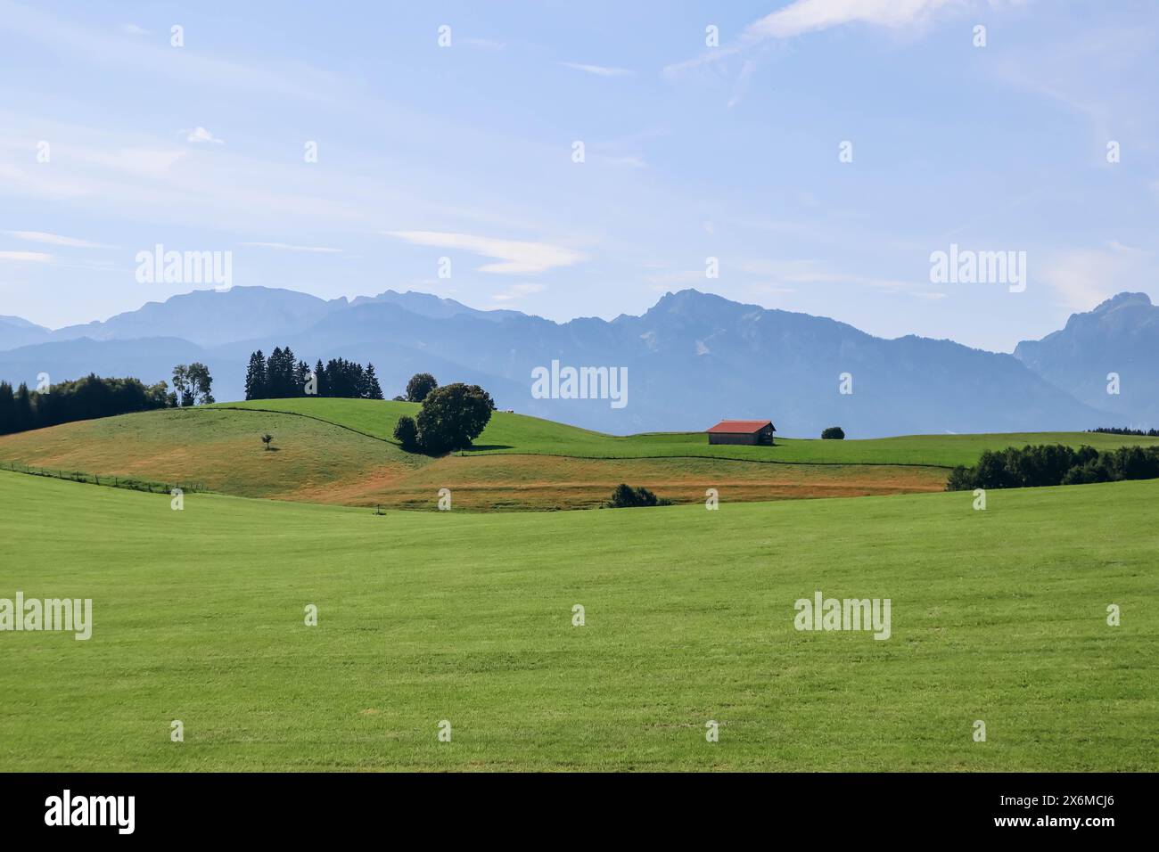 Beautiful landscapes in Bavaria - farm, green meadows and fields, Alps ...