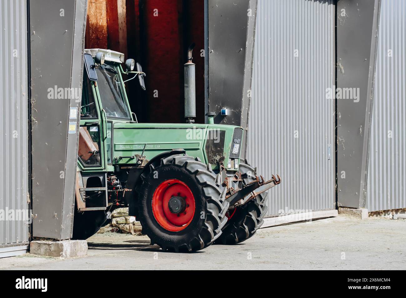 Schwangau, Germany - August 12, 2023: Tractor on the farm, half out of ...