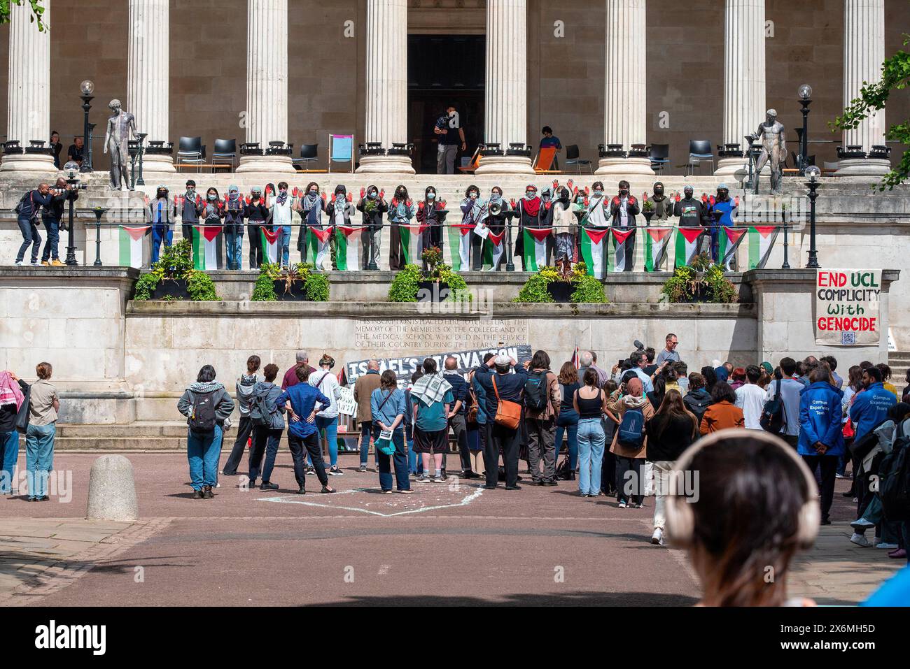 Students hold up their hands, covered with red paint referring to the ...