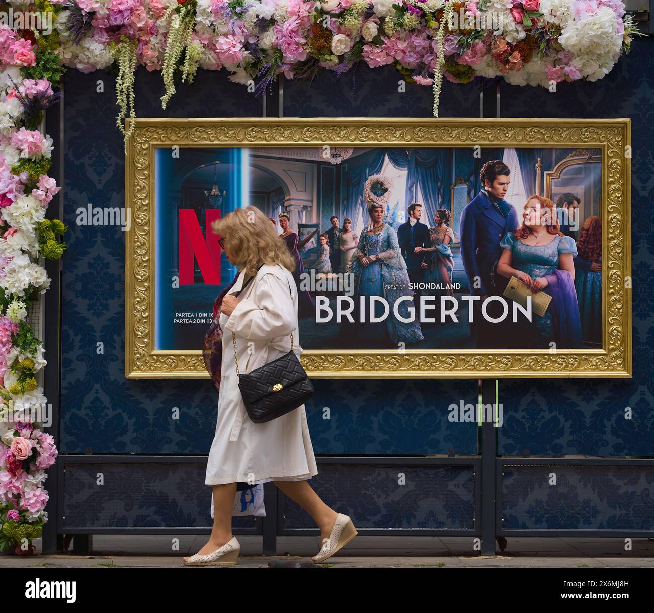 Bucharest, Romania. 15th May, 2024: People pass by an advertising of ...