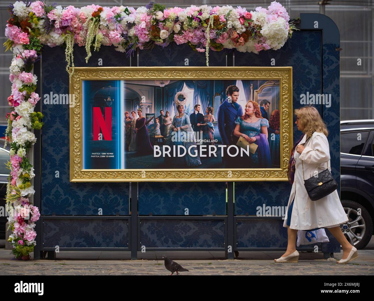 Bucharest, Romania. 15th May, 2024: People pass by an advertising of ...