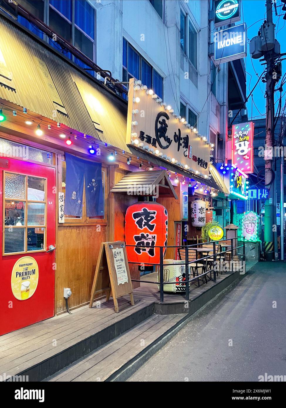 Street with restaurants and bars at dusk, neon lighting, Seoul, South ...