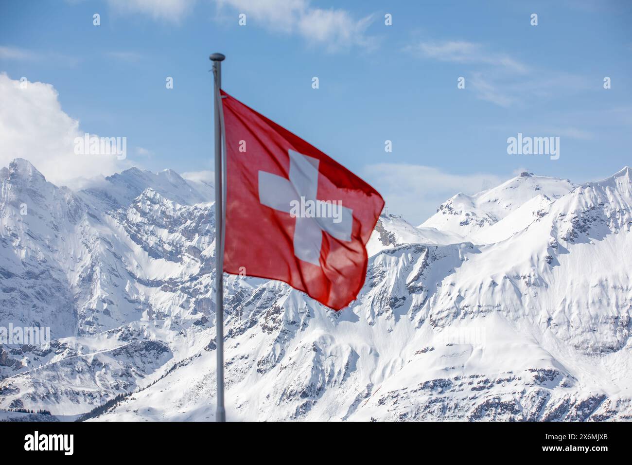Swiss flag in front of an impressive Alpine backdrop, Alps, Wengen ...