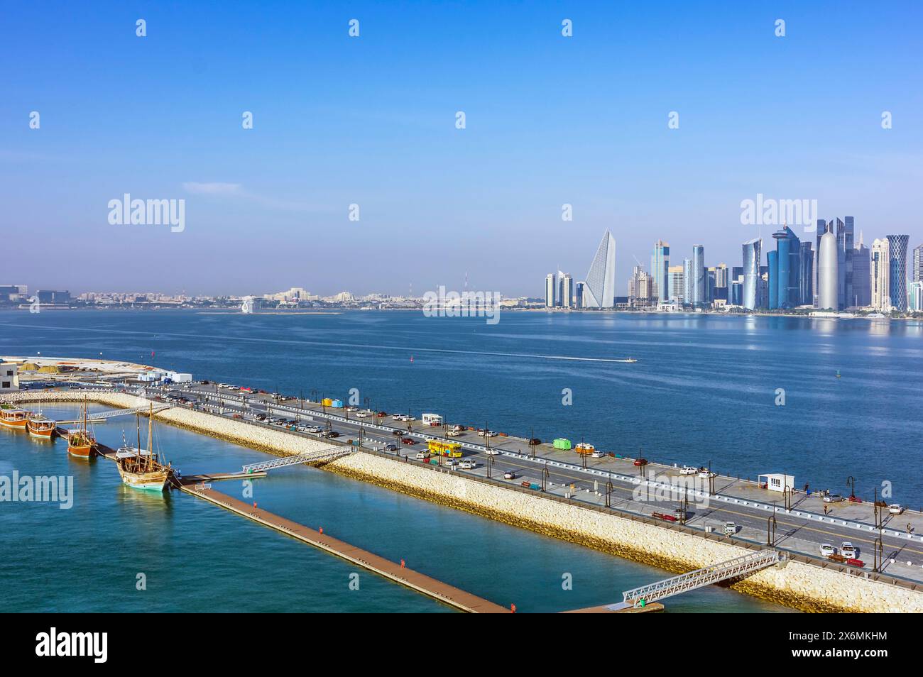 Harbor views, the Corniche with skyscrapers and ships in Doha, capital ...