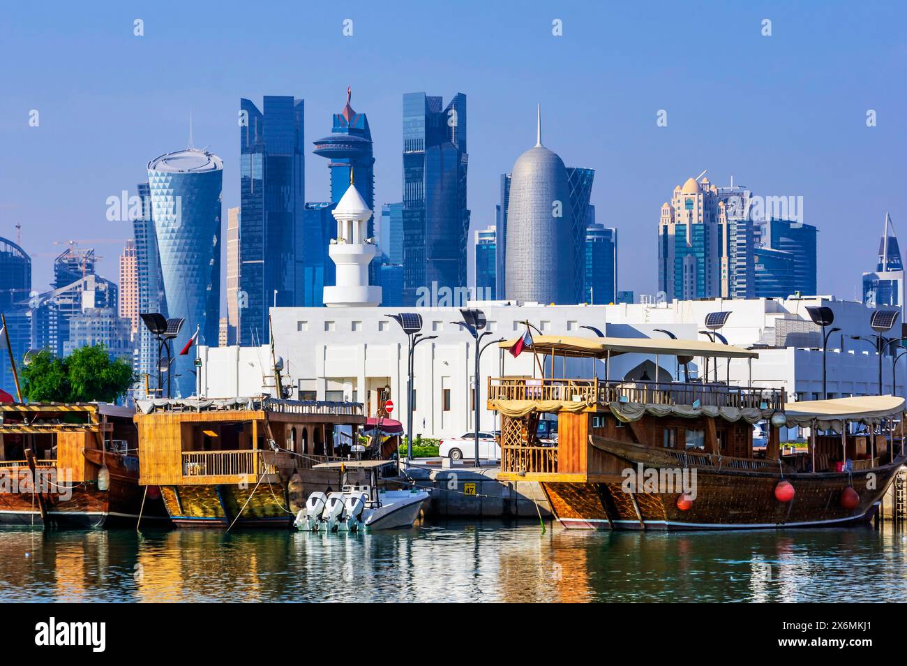Harbor views with skyscrapers and ships in Doha, capital of Qatar in ...