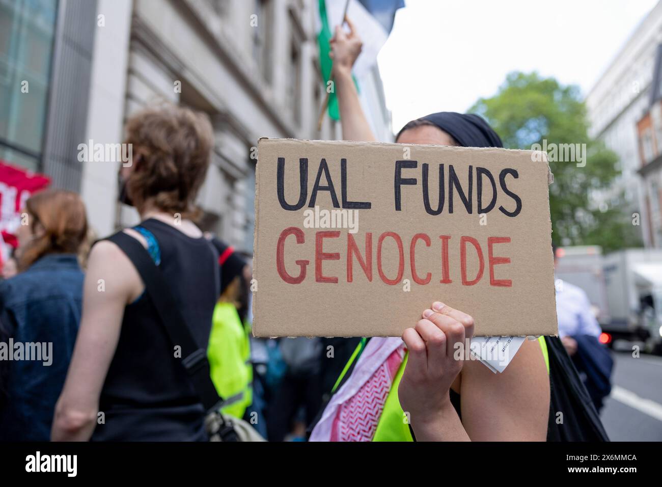 A student is seen holding a pro-Palestinian placard outside the Holborn ...