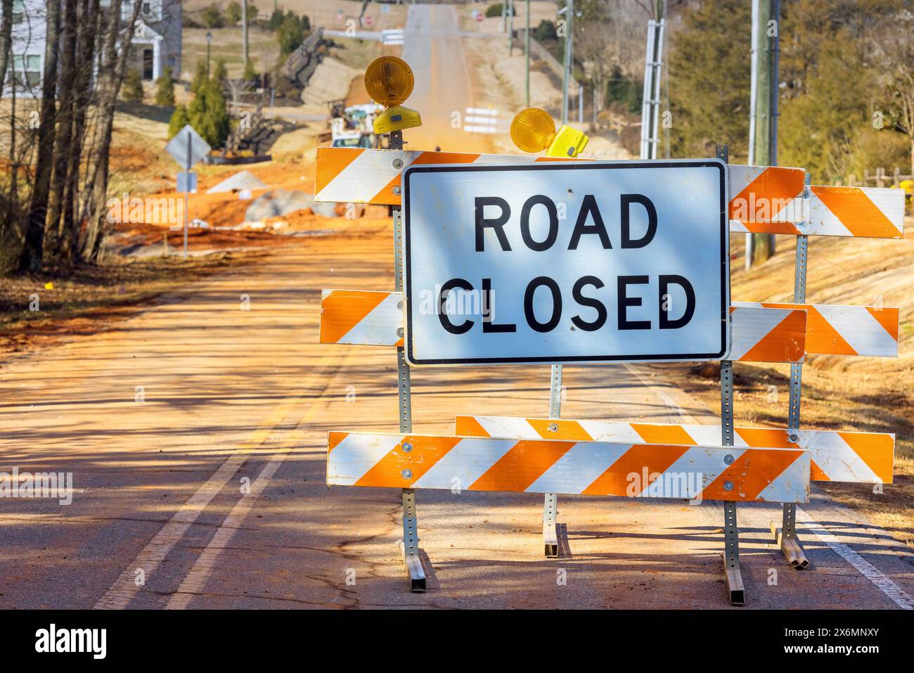 Sign indicating that road is closed with orange stripes near ...