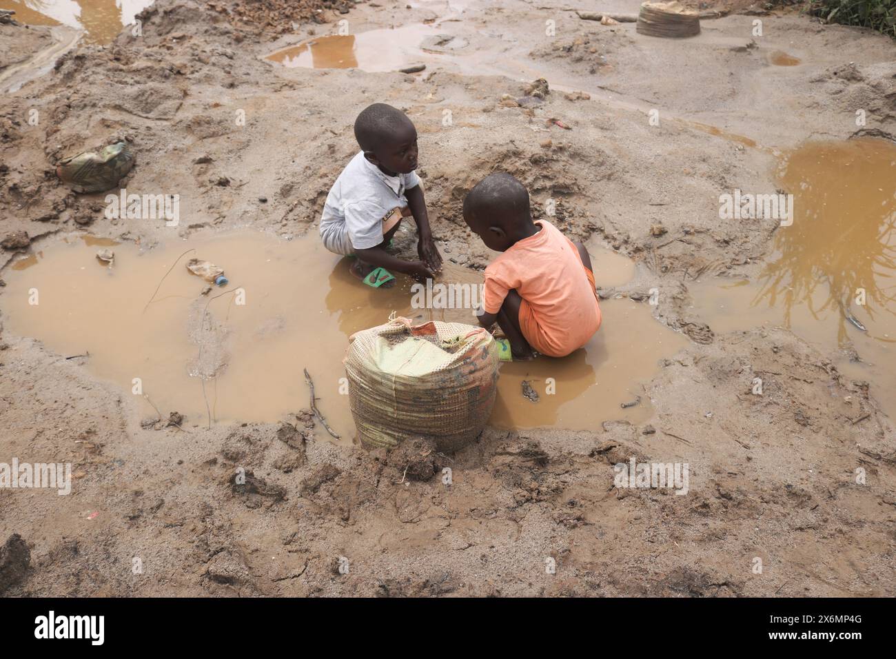 Bétaré-Oya, Cameroon. September 10, 2018. Two children search for gold ...