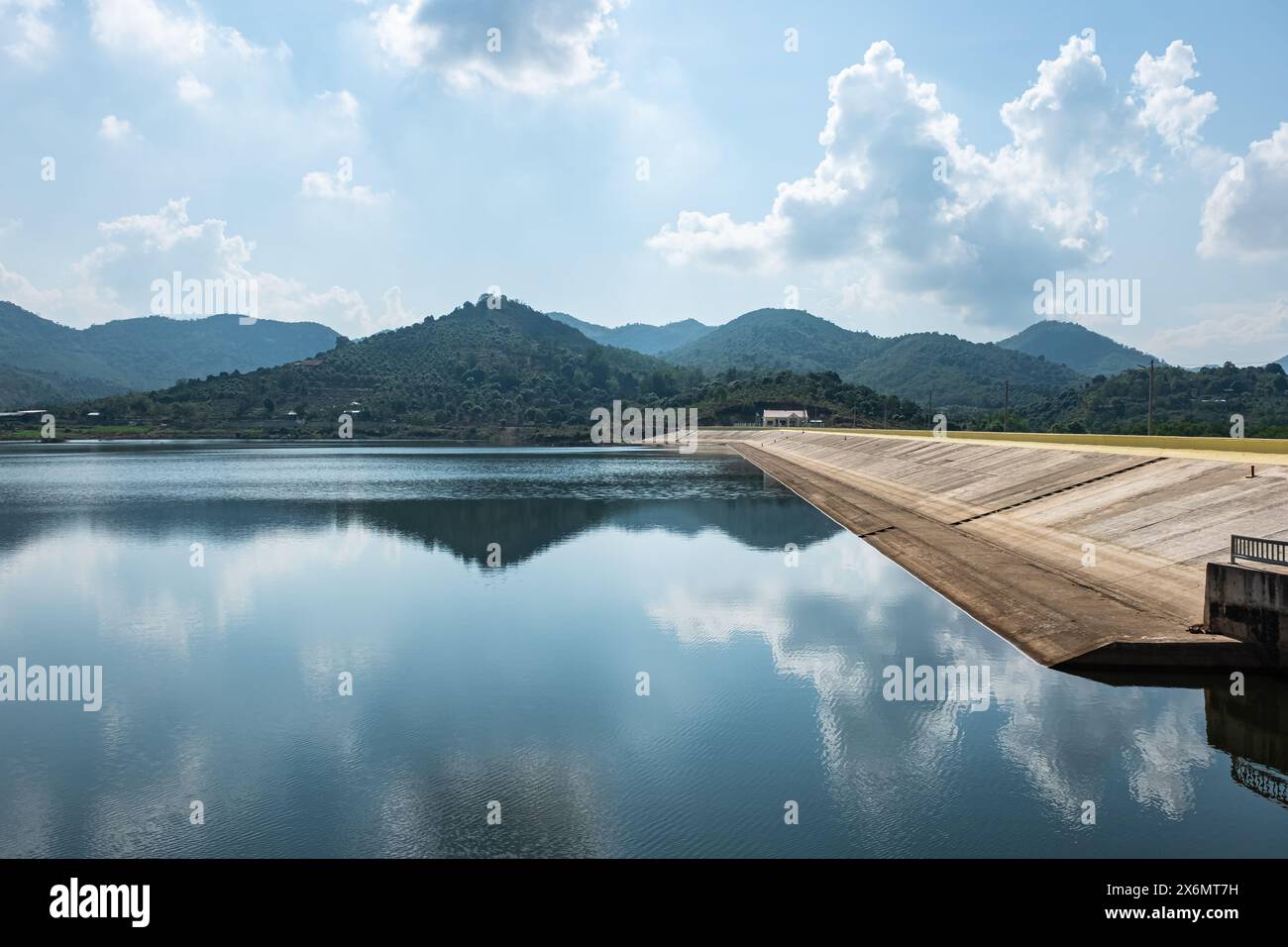Dam on Lake during sunny day in Asia. View of the river and dam in Nha ...