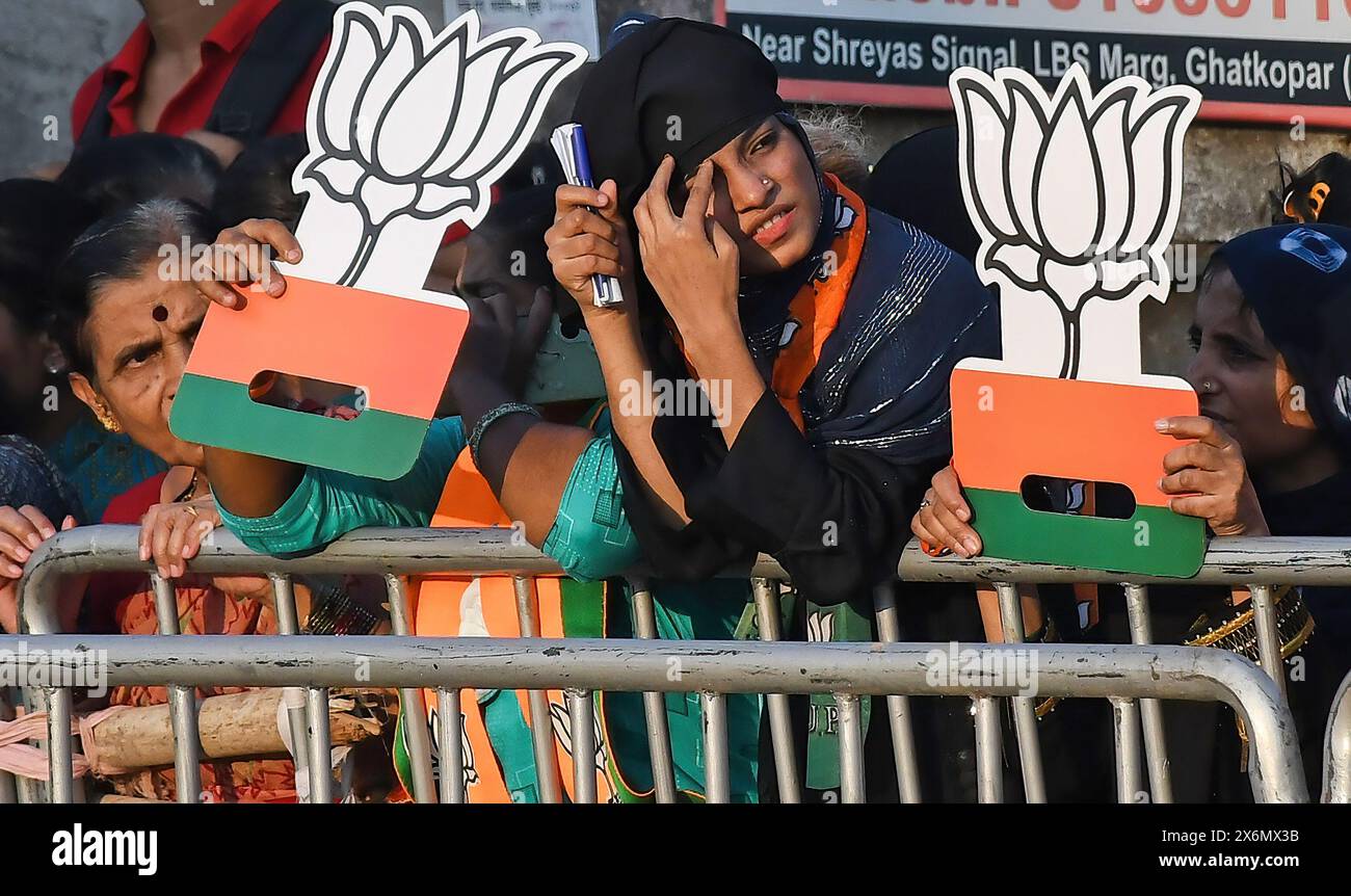 Mumbai, India. 15th May, 2024. Supporters of Bharatiya Janata Party (BJP) are seen holding a cut ...