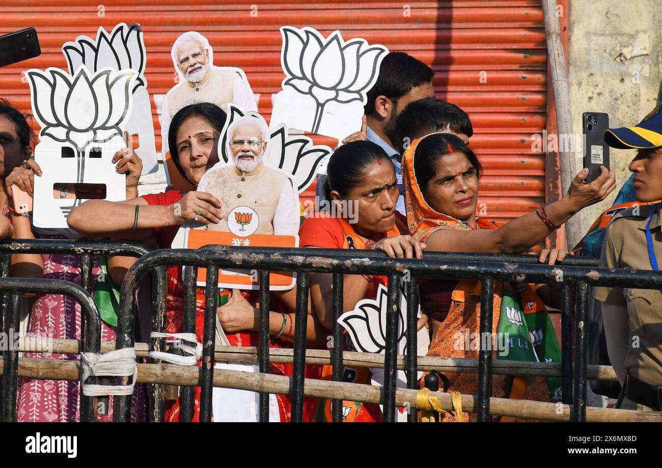 Mumbai, India. 15th May, 2024. Supporters of Bharatiya Janata Party (BJP) are seen holding a cut ...