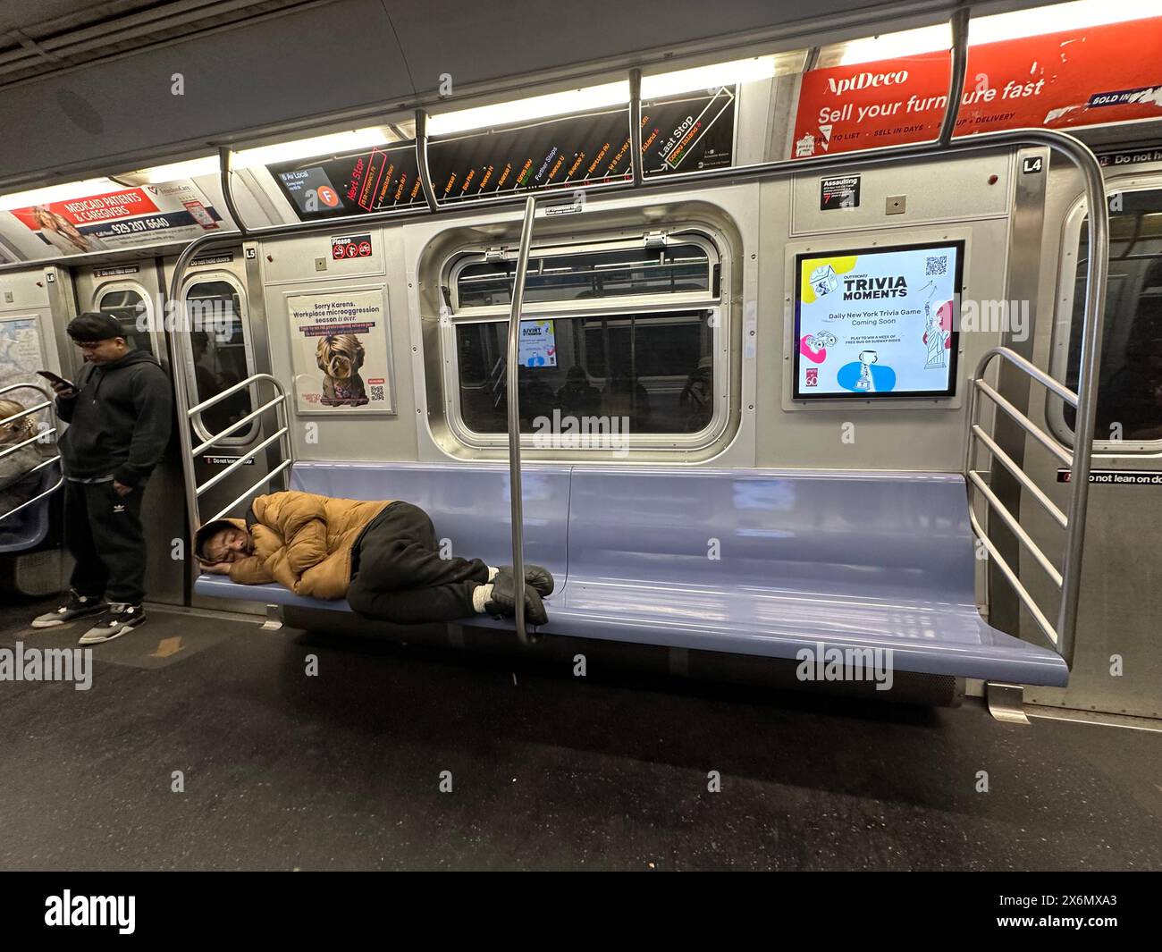 Man sleeping on NYC subway train Stock Photo - Alamy