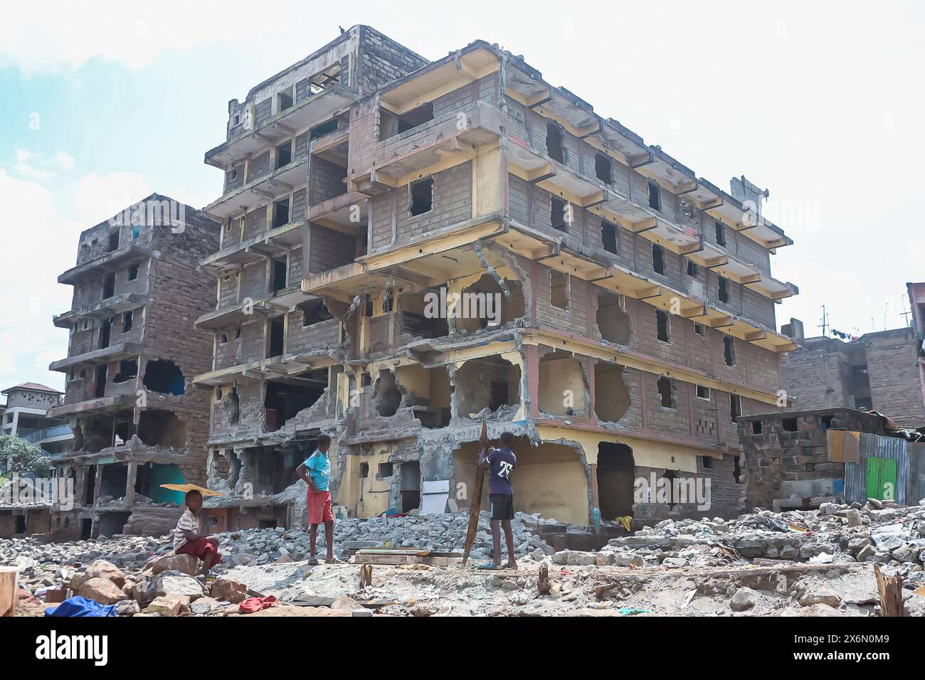 Local children sit and play around buildings demolished by multi-state ...