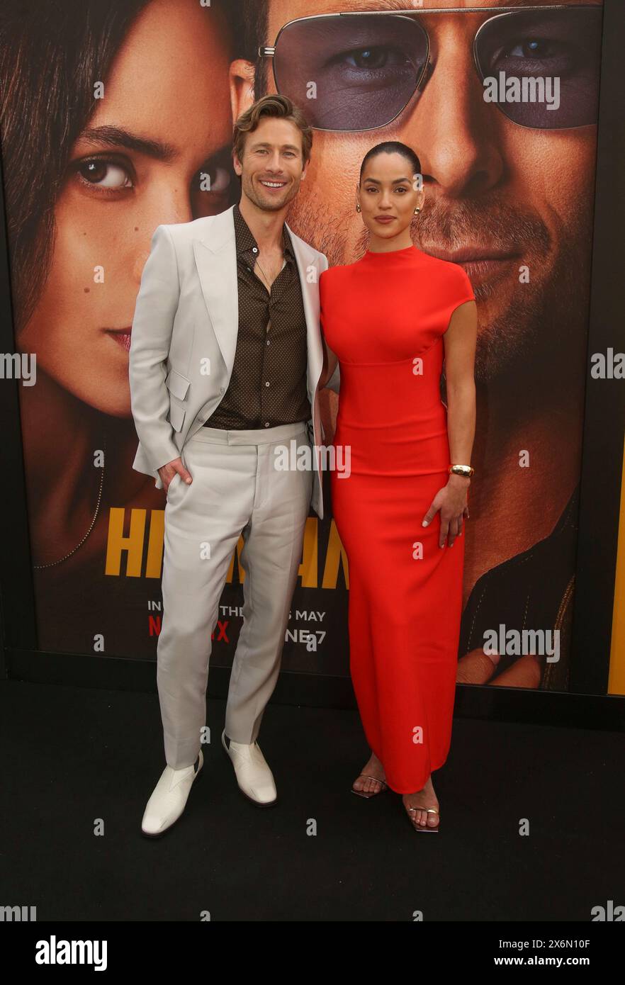 Glen Powell, left, and Adria Arjona arrive at the premiere of "Hit Man ...