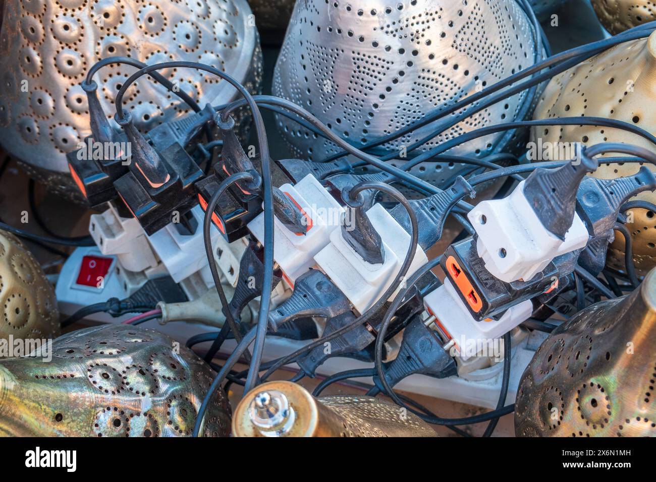 Old and damaged electric adapter power plug has many appliances are ...