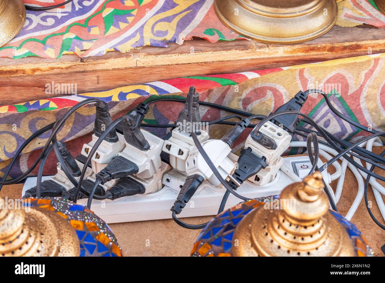 Old and damaged electric adapter power plug has many appliances are ...