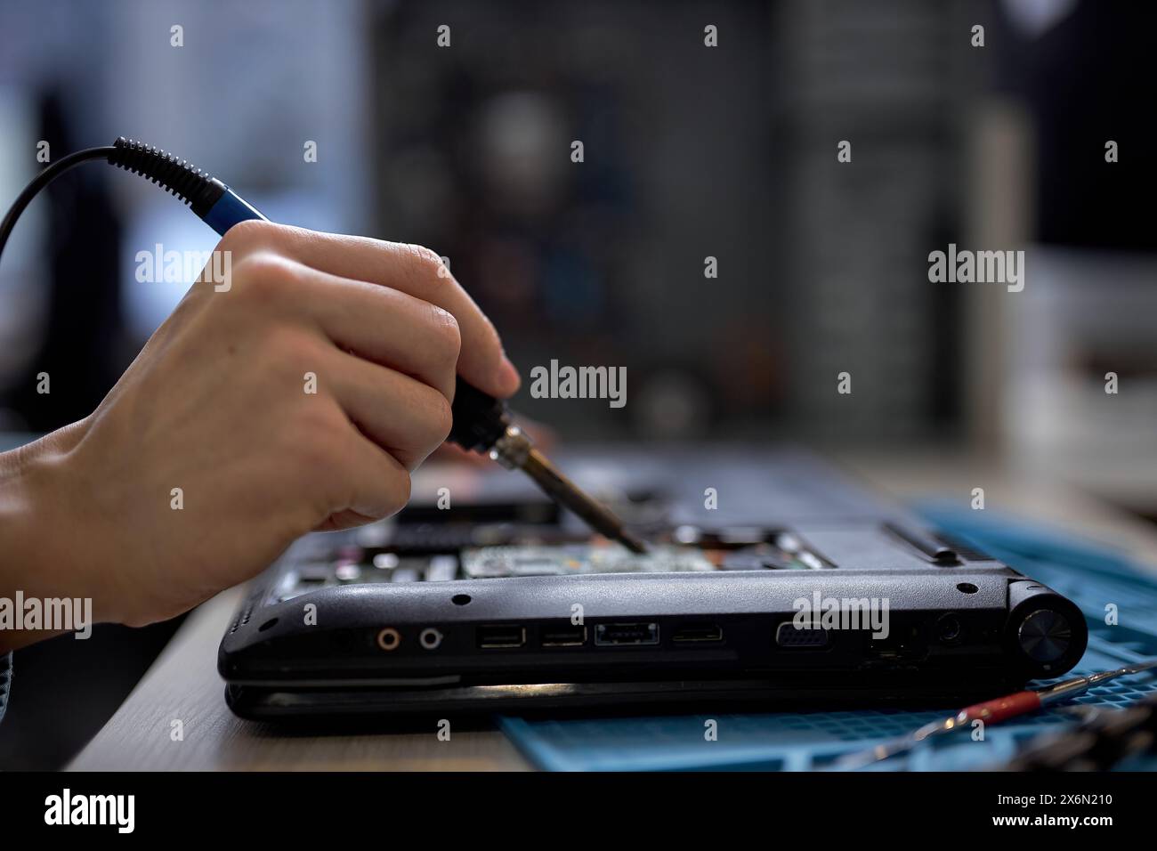 Hand technician repairing broken laptop notebook computer with tools ...