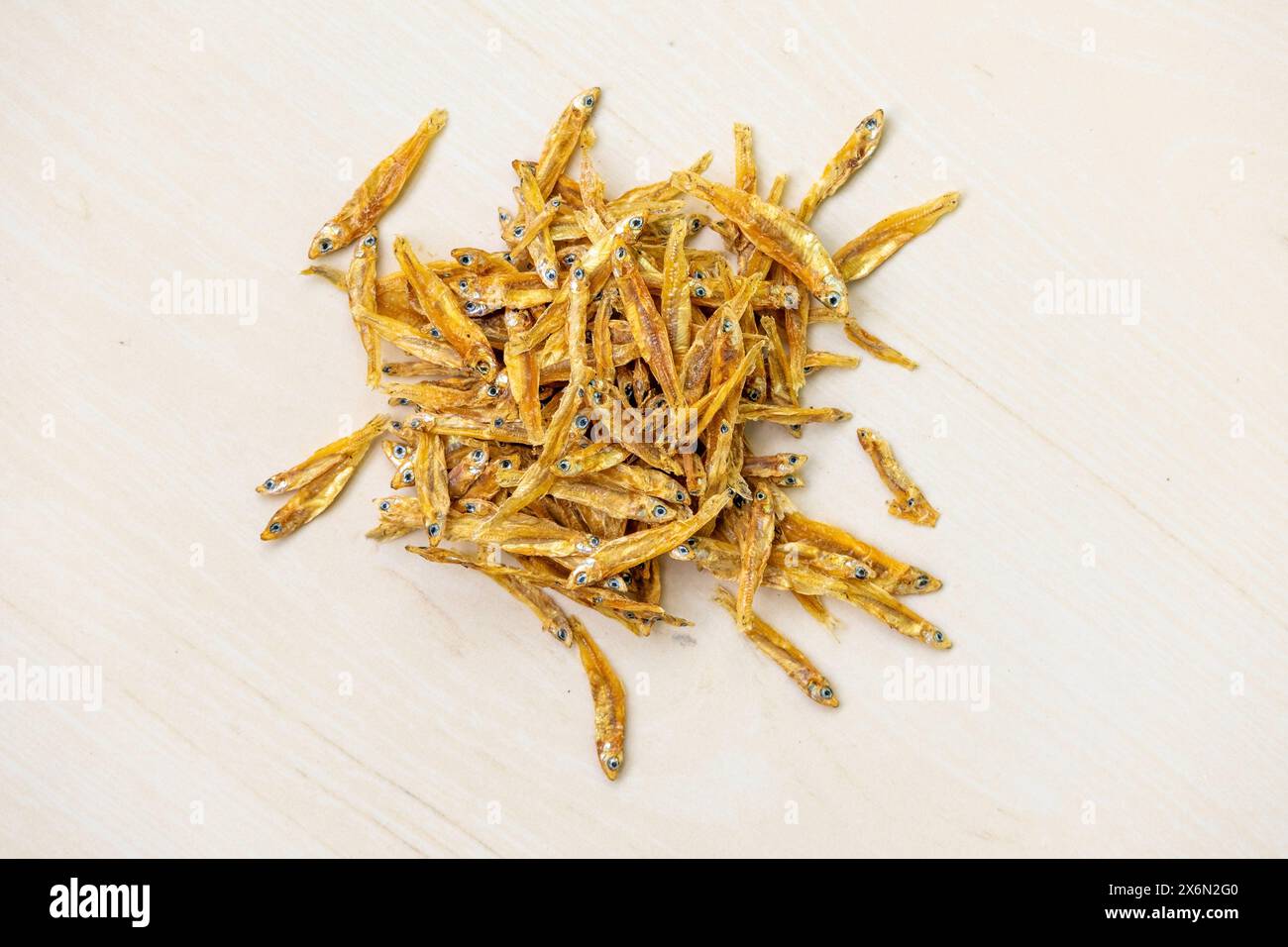 Heap of dried anchovy fish (Corica soborna) on wooden background ...