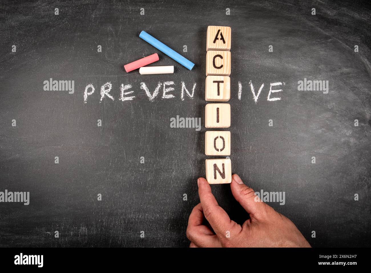 Preventive Action. Wooden block crossword puzzle and pieces of chalk on ...