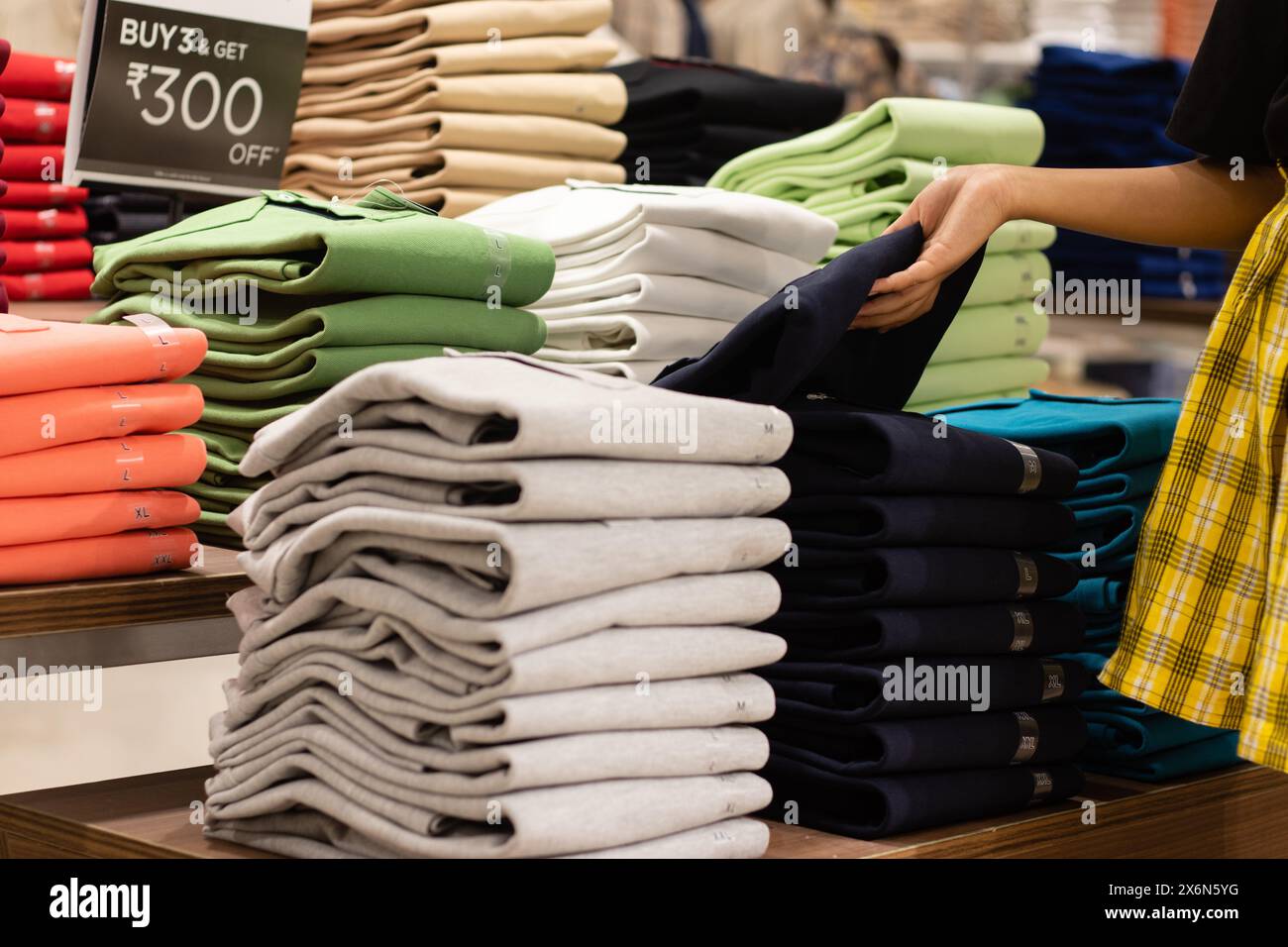 A human hand choosing from rack in a shopping mall of India containing ...