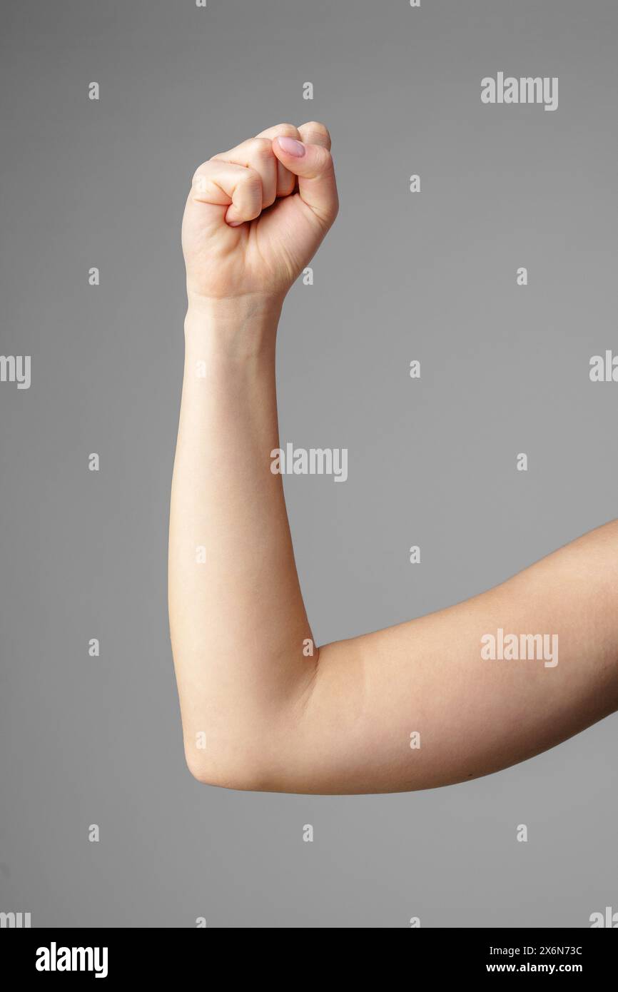 Woman Holding Arm Up in the Air with Gesture Stock Photo - Alamy
