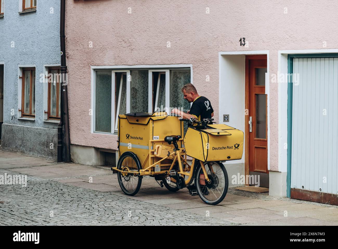 Fussen, Germany - August 14, 2023: The postman delivers mail on the ...