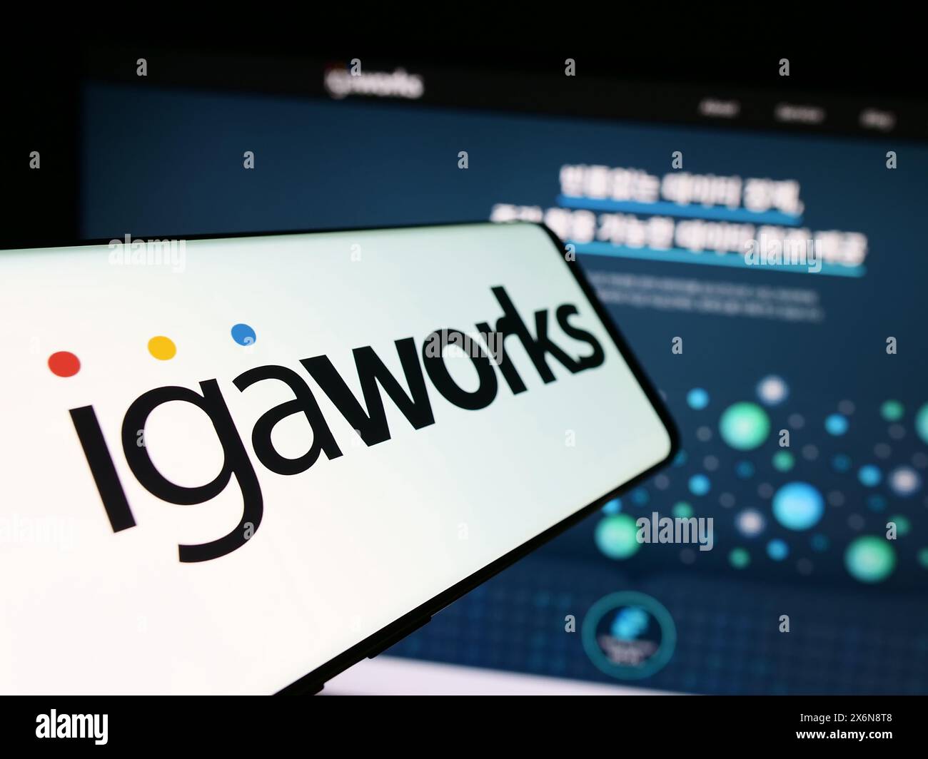 Smartphone with logo of South Korean digital marketing company IGAWorks in front of business ...
