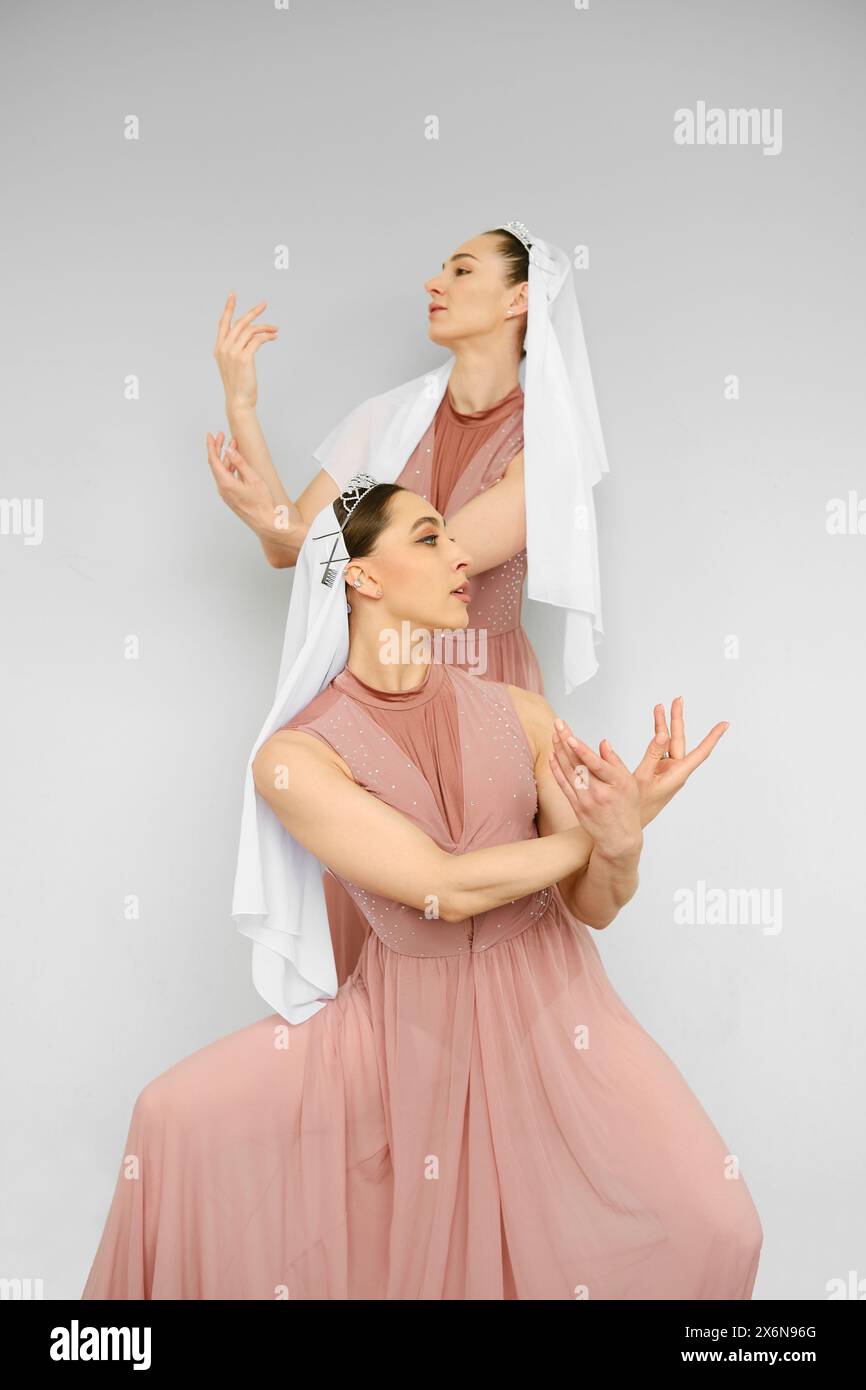 Two female dancers perform hand movements on grey background Stock ...