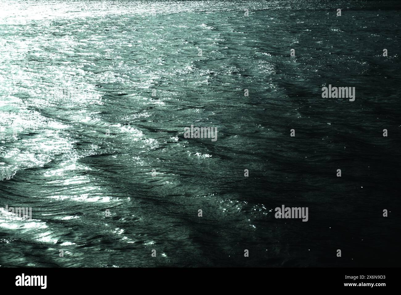 Sunlight spreads over the aqua green choppy waters of the Serpentine ...