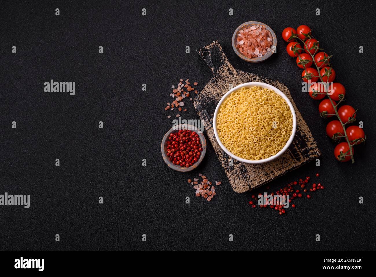 Raw anellini pasta from durum wheat with salt and spices on a dark ...