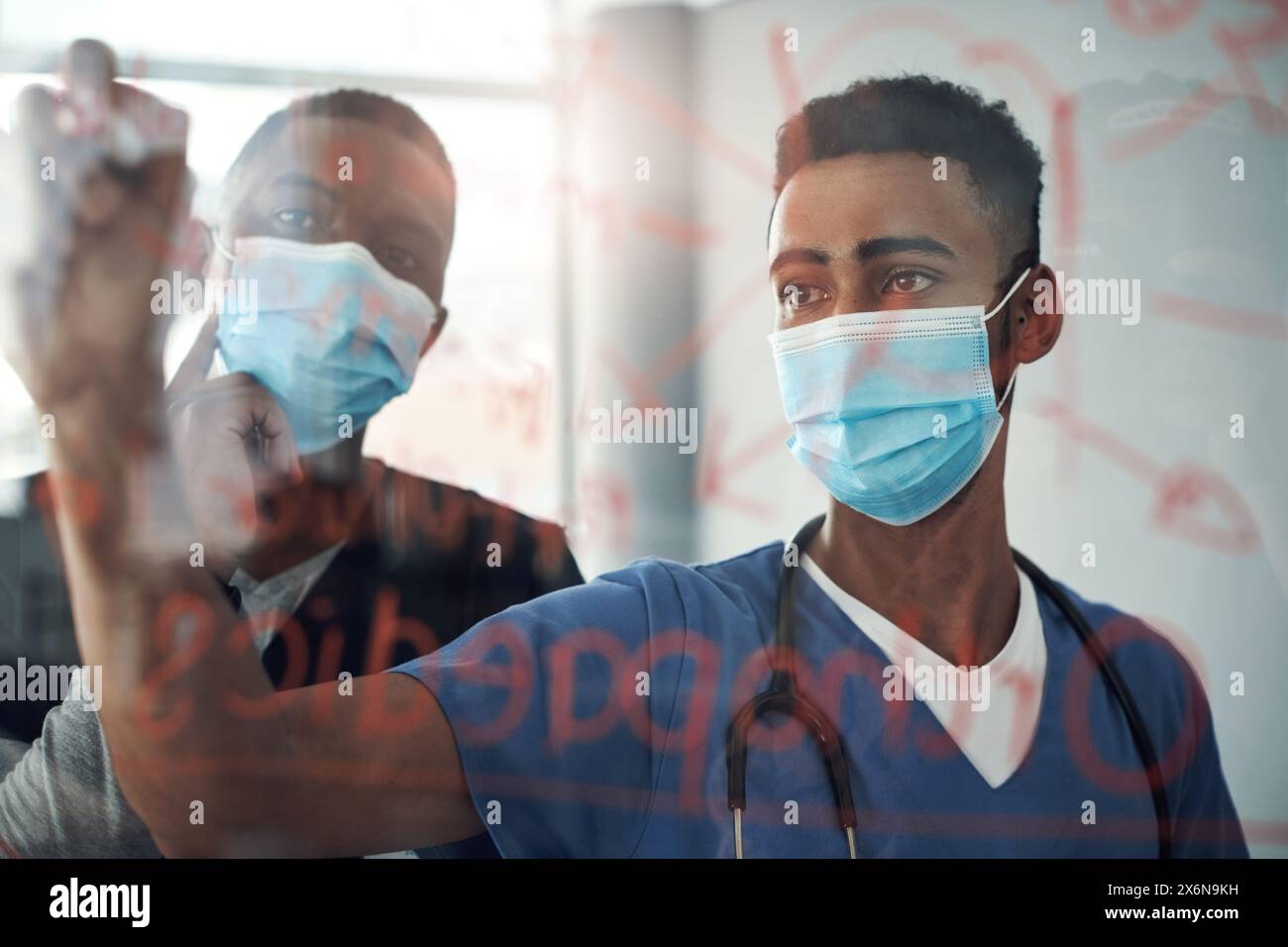 Doctors, solution and writing on glass board for vaccine treatment plan ...