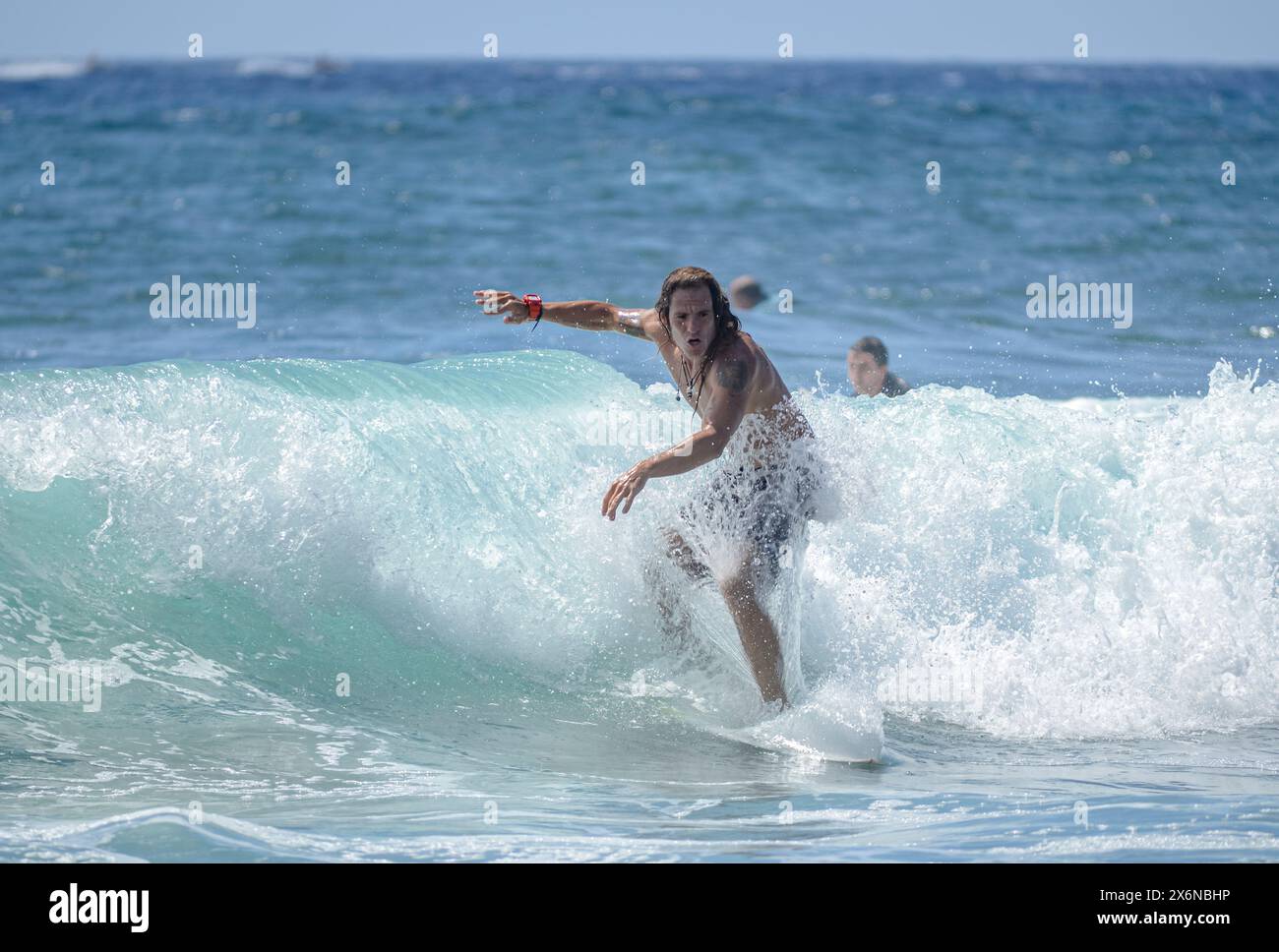 surfing on the waves in the ocean Stock Photo - Alamy