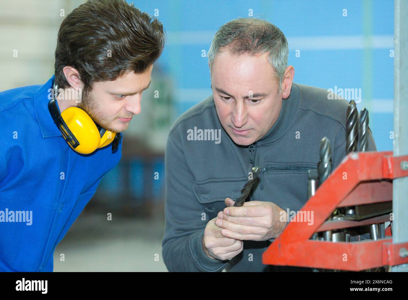 team of engineers having discussion in factory Stock Photo - Alamy