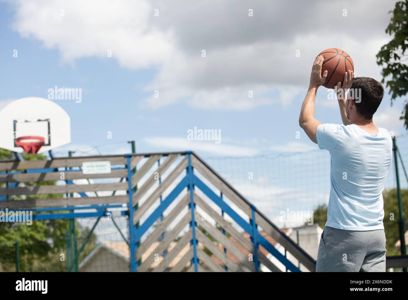 basketball player makes a throw on outdoor court Stock Photo - Alamy