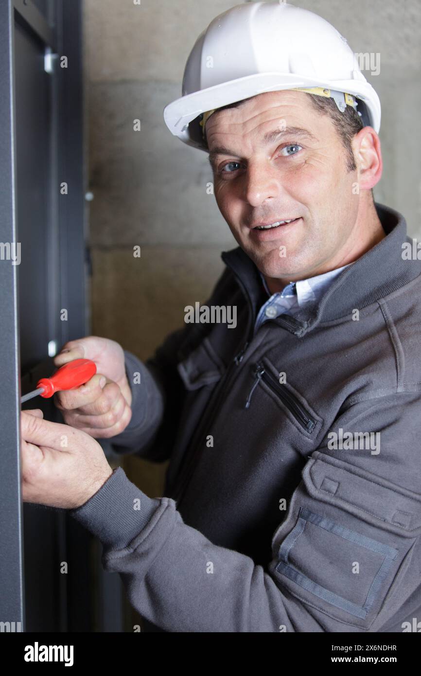 a man screws a frame Stock Photo - Alamy