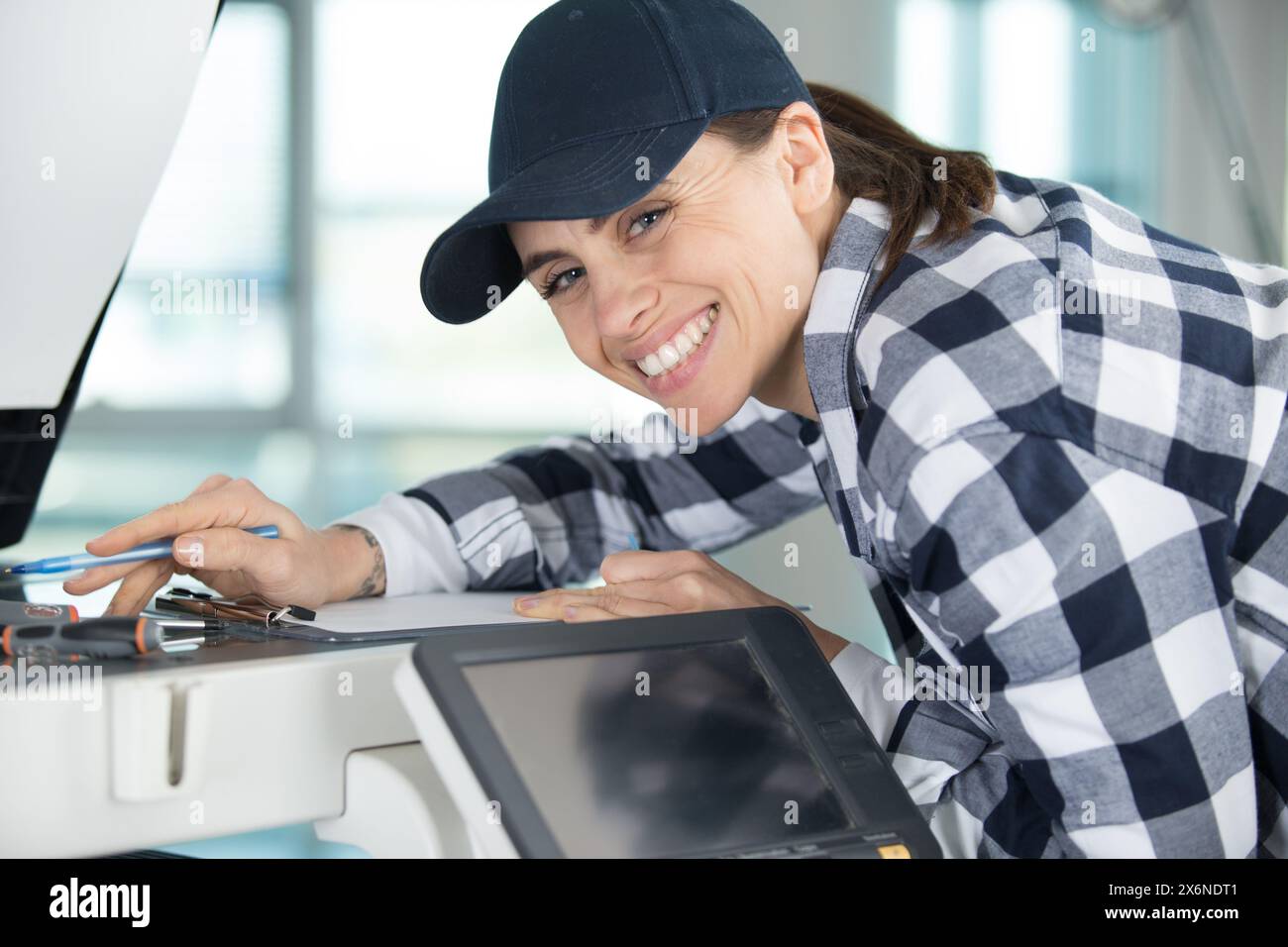 happy woman doing printer maintenance Stock Photo - Alamy