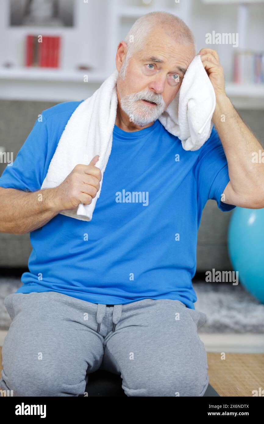 Elderly man wiping head hi-res stock photography and images - Alamy