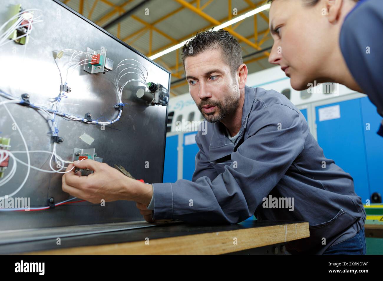 technicians fixing cables of a machine Stock Photo - Alamy