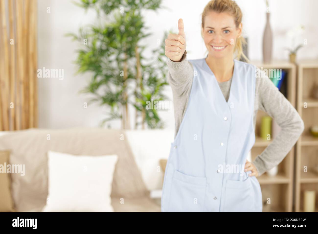 portrait of smiling beautiful young housekeeper Stock Photo - Alamy
