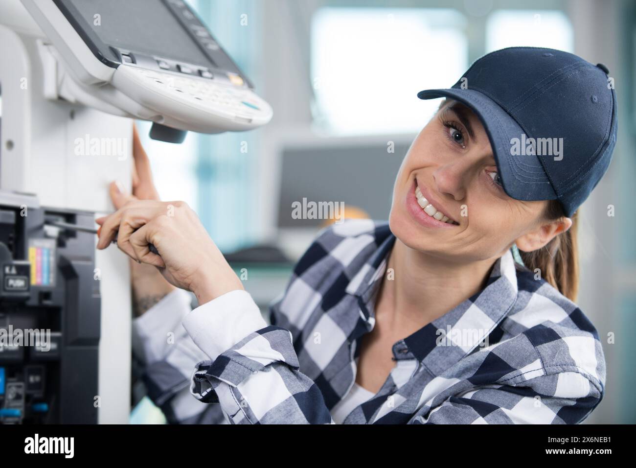 happy woman fixing a printer Stock Photo - Alamy