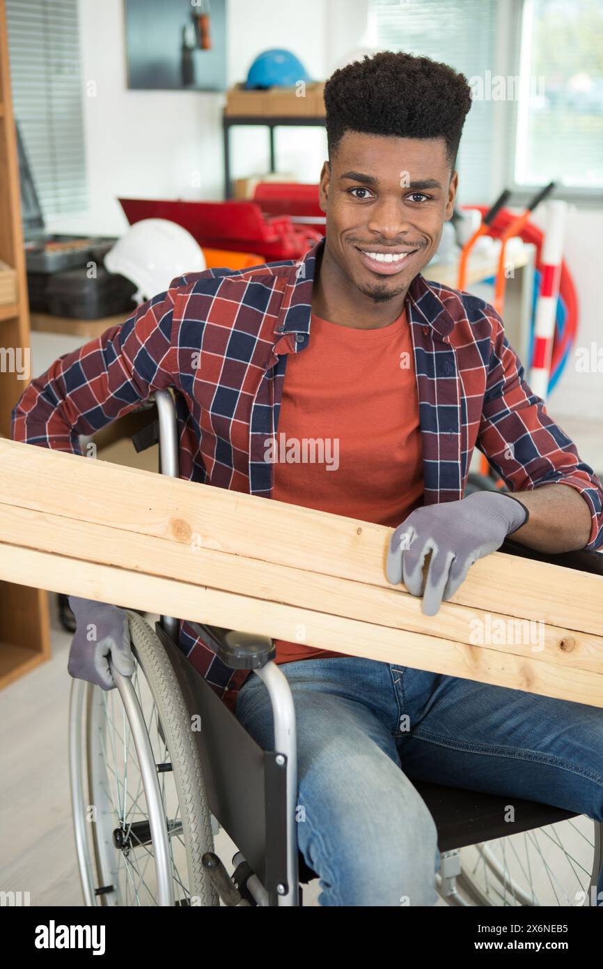 disabled worker in wheelchair sanding wood indoors Stock Photo - Alamy